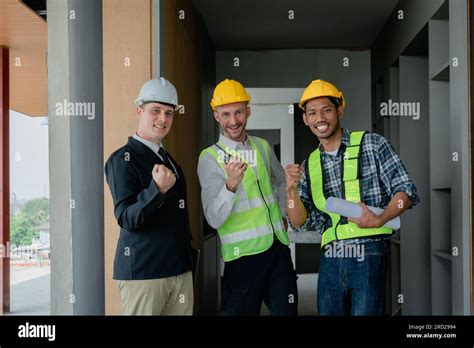 Multi Ethnic Engineer Brainstorming And Measuring For Cost Estimating