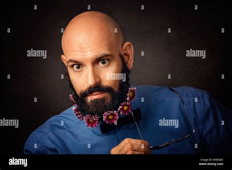 Portrait Of Unshaven Man With Beard And Moustache With Chrysanthemum
