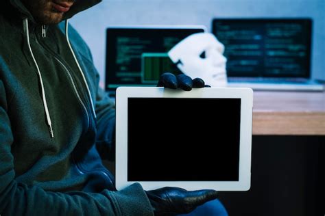 premium photo hacker holding tablet