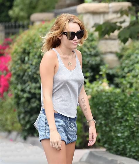 Miley Cyrus Showing Pokies Braless Wearing Skimpy Top And Denim Shorts