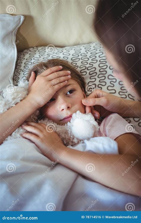 Mother Checking Daughters Temperature Stock Photo Image Of Household Homey