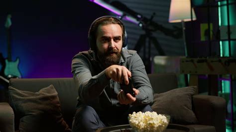 Man Looking In Disbelief At Tv Screen While Playing Videogames Receiving Game Over Message On