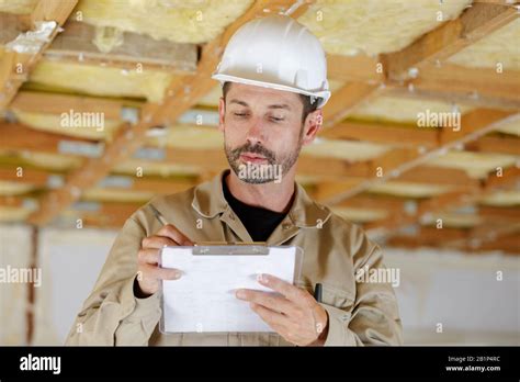 A Builder Using A Clipboard Stock Photo Alamy