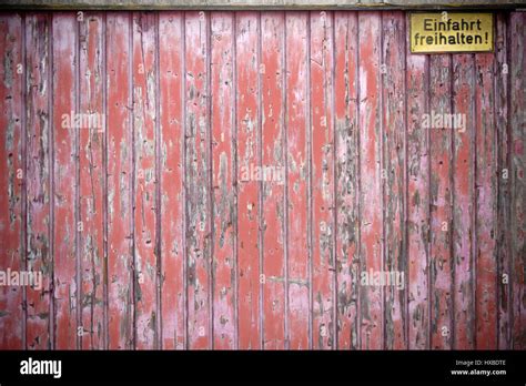 A Heavily Worn Wooden Gate With A Yellow Sign Keep Exit Stock Photo Alamy