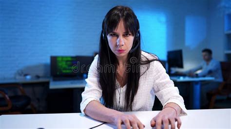 Serious Slim Beautiful Woman Putting On Headphones And Typing On Keyboard Portrait Of