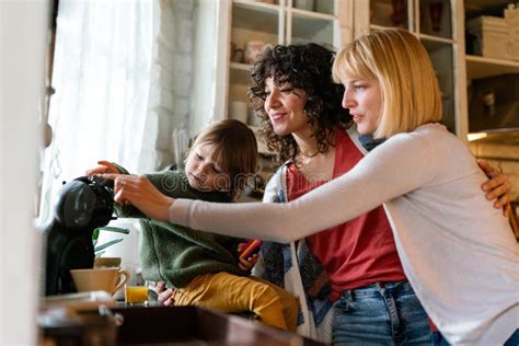Loving Homosexual Women Couple Playing With Their Son While Spending