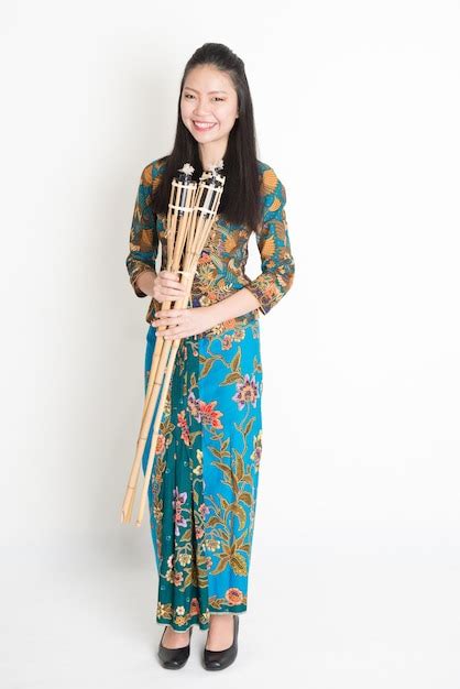 Premium Photo Full Length Portrait Of Smiling Woman Holding Tiki Torch On White Background