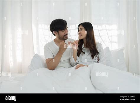Asian Romantic Couple In Bed Enjoying Sensual Foreplay Happy Sensual Young Couple Lying In Bed