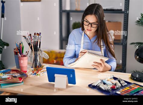 Young Woman Artist Using Touchpad Drawing On Notebook At Art Studio