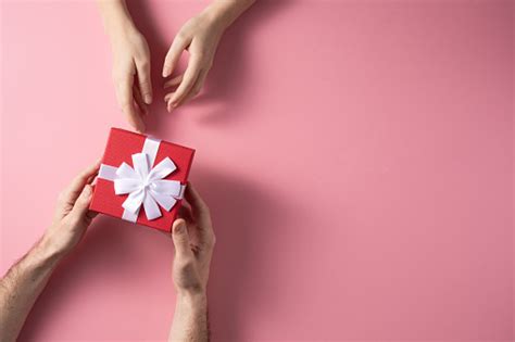 발렌타인 데이 축하 개념입니다 사랑하는 사람의 좋은 선물 섬세한 분홍색 배경에 남자와 여자의 활 손이 상자 공간을 복사합니다 플랫 레이 2월에 대한 스톡 사진 및 기타