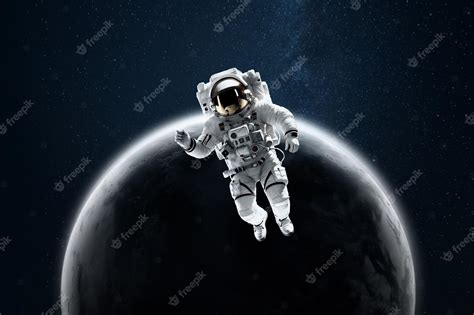 Premium Photo Astronaut In A White Spacesuit In Space On The Background Of The Moon Exploring