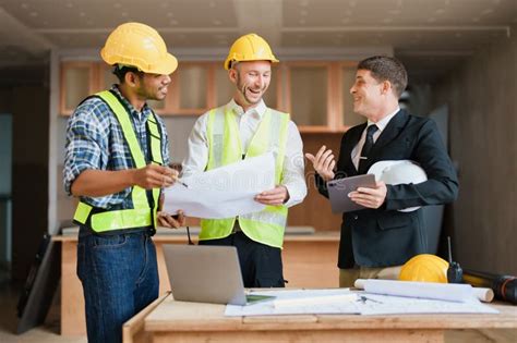 Multi Ethnic Engineer Brainstorming And Measuring For Cost Estimating