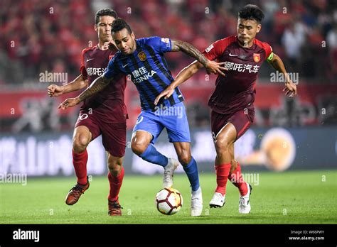 Brazilian Football Player Alex Teixeira Of Jiangsu Suning Center Dribbles Against Players Of
