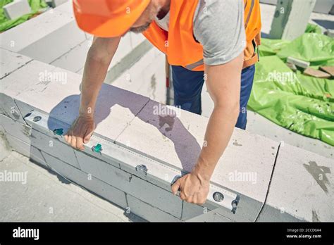 Builder Checking The Degree Of Levelness With A Spirit Level Stock