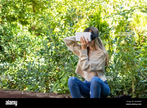 Young Woman Sitting And Putting On Fpv Glasses For Virtual Reality