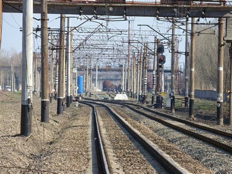 Image Depicts A Parallel Rail Track System With Overhead Power Lines