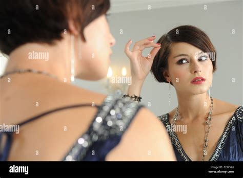 Female Short Brunette Hair Wearing A Blue Embellished Evening Dress