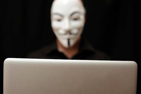 Premium Photo Member Of The Anonymous Hacker Group In Front Of The Laptop