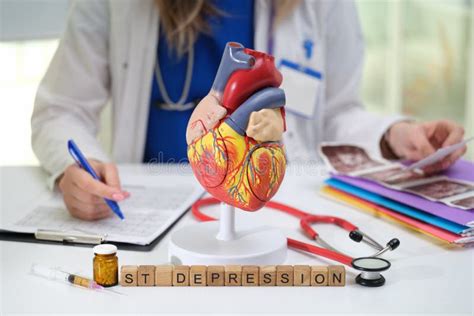 A Doctor Examines The Heart And Focuses On The Patients Depression Using Medical Records Stock