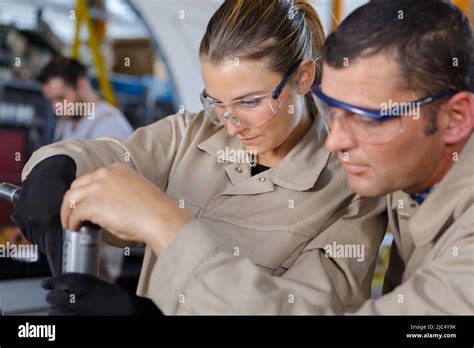Female Apprentice Training To Use Mechanical Equipment Stock Photo Alamy