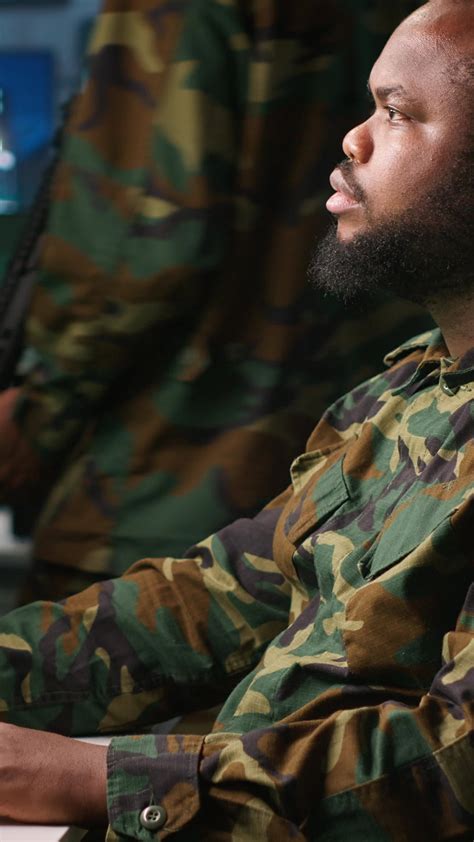 Vertical Military Soldier In Mission Command Post Overseeing National Safety Operations Talking