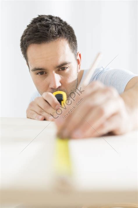 Mid Adult Man Measuring Table With Tape Measure Photo Picture And HD Photos Free Download On