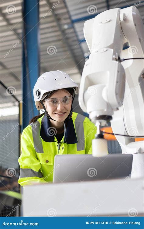 Female Technician Engineer Using Laptop Checking Automation Robotics At Industrial Modern