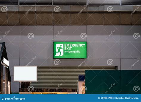 Large Emergency Exit Sign Green Light Box Is Placed On The Wall Of Exhibition Hall Thai Letter