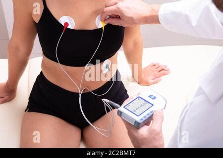 Woman Wearing Holter Monitor Device For Daily Monitoring Of An Electrocardiogram Stock Photo Alamy