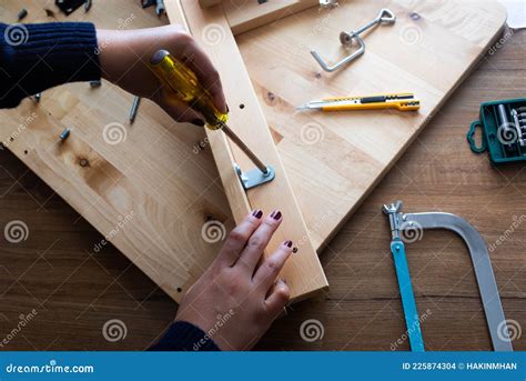Woman Assembly Wooden Furniturefixing Or Repairing House With