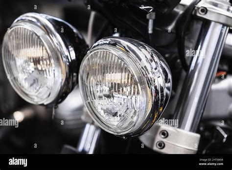 Round Front Headlights Of A Shiny Black Road Motorcycle Close Up Photo
