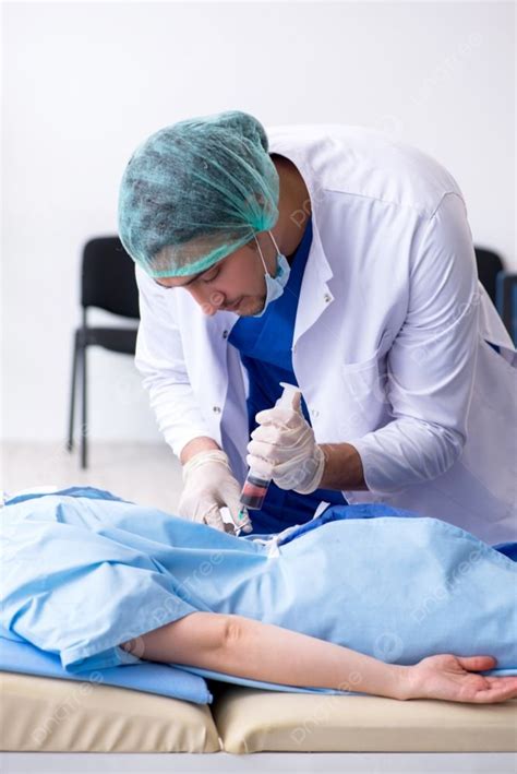 The Female Patient Getting An Injection In The Clinic Female Patient Getting An Injection In The
