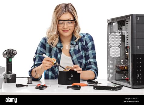 Female PC Technician Soldering A Chip From A Desktop Computer Isolated On White Background Stock