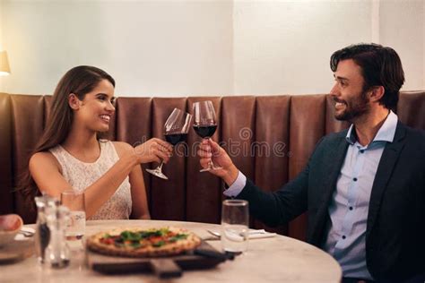 Heres To Love A Happy Young Couple Enjoying A Romantic Dinner Date At