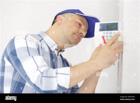 Technician Installing Security System Using Screwdriver Stock Photo Alamy