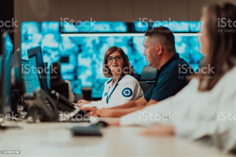 Cctv 모니터링실에서 여러 대의 모니터를 보고 있는 보안 데이터 센터 운영자 그룹 의심스러운 활동에 대해 여러 화면을