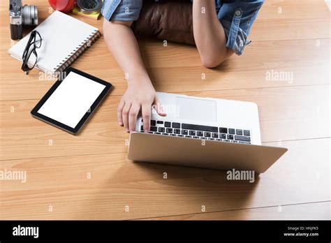 Woman Lying On Wooden Floor With Computer Notebook And Tablet Stock Photo Alamy