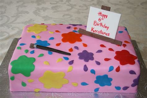 A Birthday Cake Decorated With Flowers And A Sign