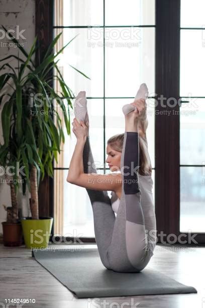요가를 하 고 다층 건물의 큰 창 배경에 회색 양탄자에 스트레칭 흰색 스포츠에서 젊은 아름 다운 체육 여자 금발 가냘픈에 대한 스톡 사진 및 기타 이미지 Istock