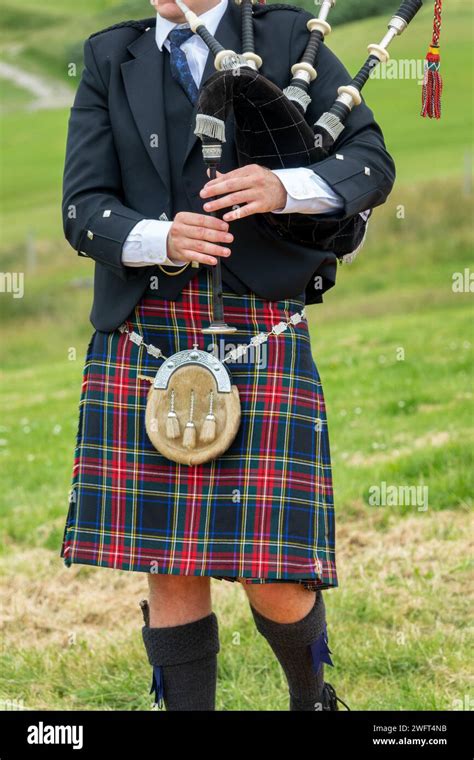 Close Up Of A Scottish Bagpiper Dressed In Traditional Kilt In The