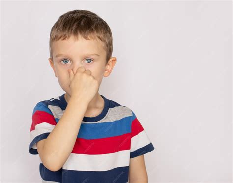 Premium Photo Little Boy Holding His Nose Because Of A Bad Smell