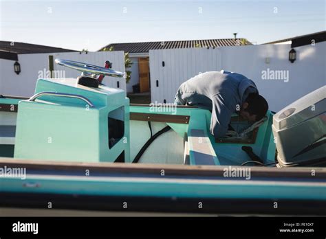 Man Checking Motor Boat Stock Photo Alamy