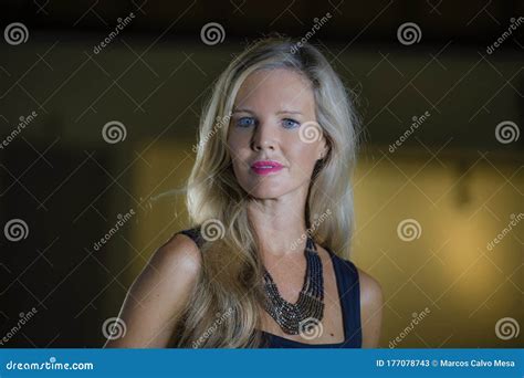 Lifestyle Portrait In Dim Light Of Beautiful And Classy Blond Hair