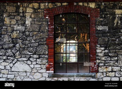 An Old Translucent Window In A Vacant Building With Stone Wall Stock