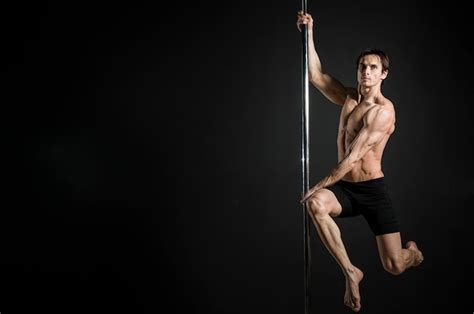 Portrait Of Male Model Performing A Pole Dance Free Photo