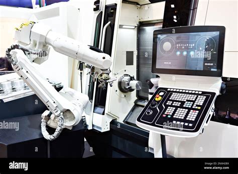 Robotic Arm And Cnc Lathe Machine Stock Photo Alamy