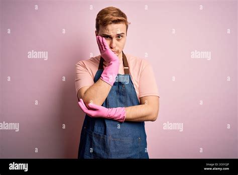 Young Handsome Redhead Cleaner Man Doing Housework Wearing Apron And