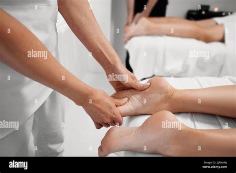 Foot Massage With Massage Oil For Female Feet While Relaxing And Resting With Her Partner At Spa