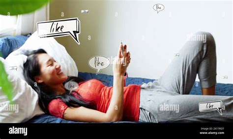 Image Of Social Media Text In Speech Bubbles Over Asian Woman Using Smartphone Stock Photo Alamy