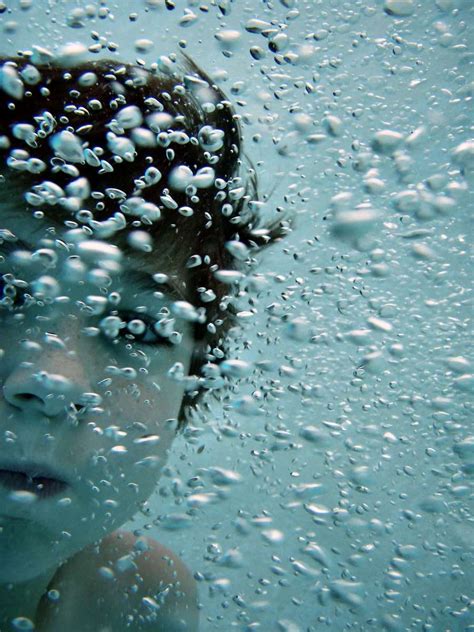 Boys Face Emerging Through Bubbles In Clear Blue Water Free Stock
